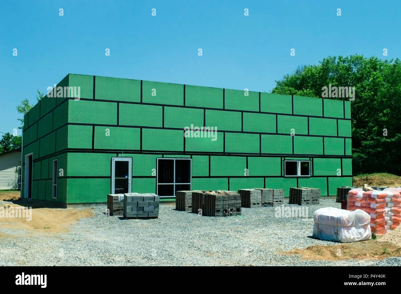 Horizontal shot of a building under construction with green insulation ...