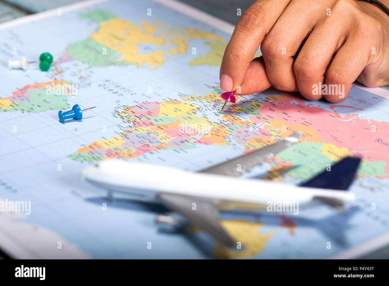 Close up view of man or woman pointing at places on world map. Travel ...