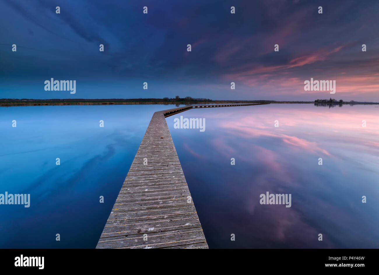 wooden walk path on water at dawn Stock Photo - Alamy