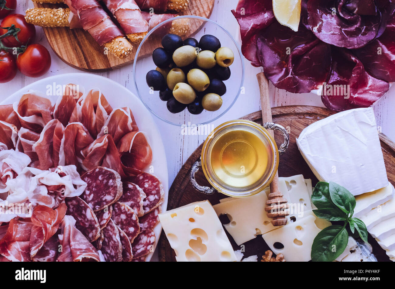 Table full of mediterranean appetizers, tapas or antipasto. Assorted ...