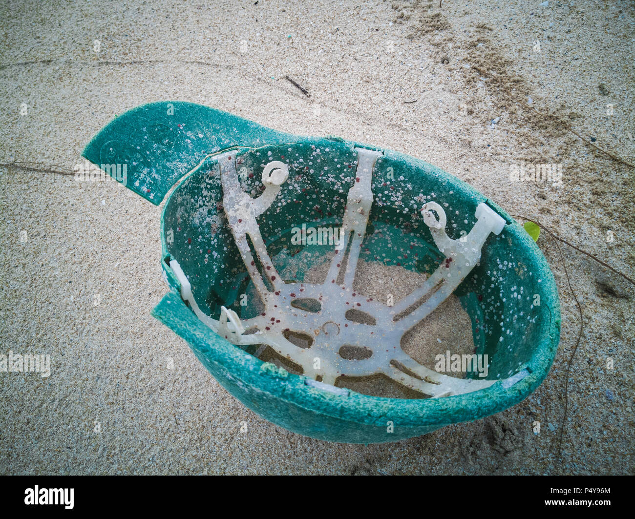 Discarded plastic safety hard hat on sandy beach Stock Photo - Alamy