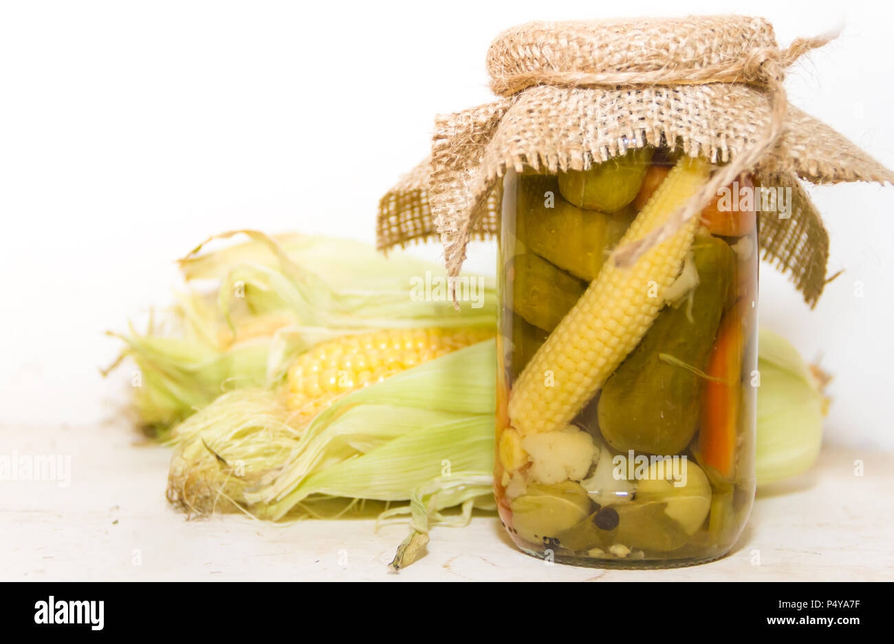 pickled corn and other vegetables in a jar Stock Photo - Alamy