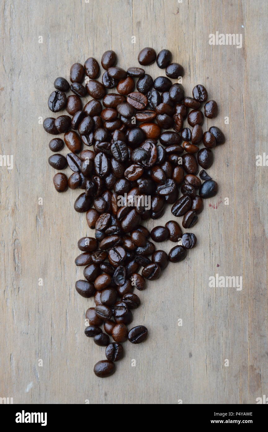 dark roast coffee bean on wooden board Stock Photo - Alamy