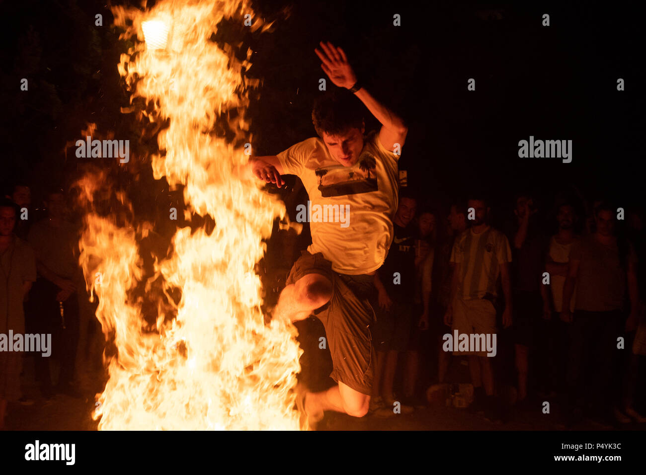Madrid, Spain. 23rd June, 2018. A man jumping through the fire of a ...