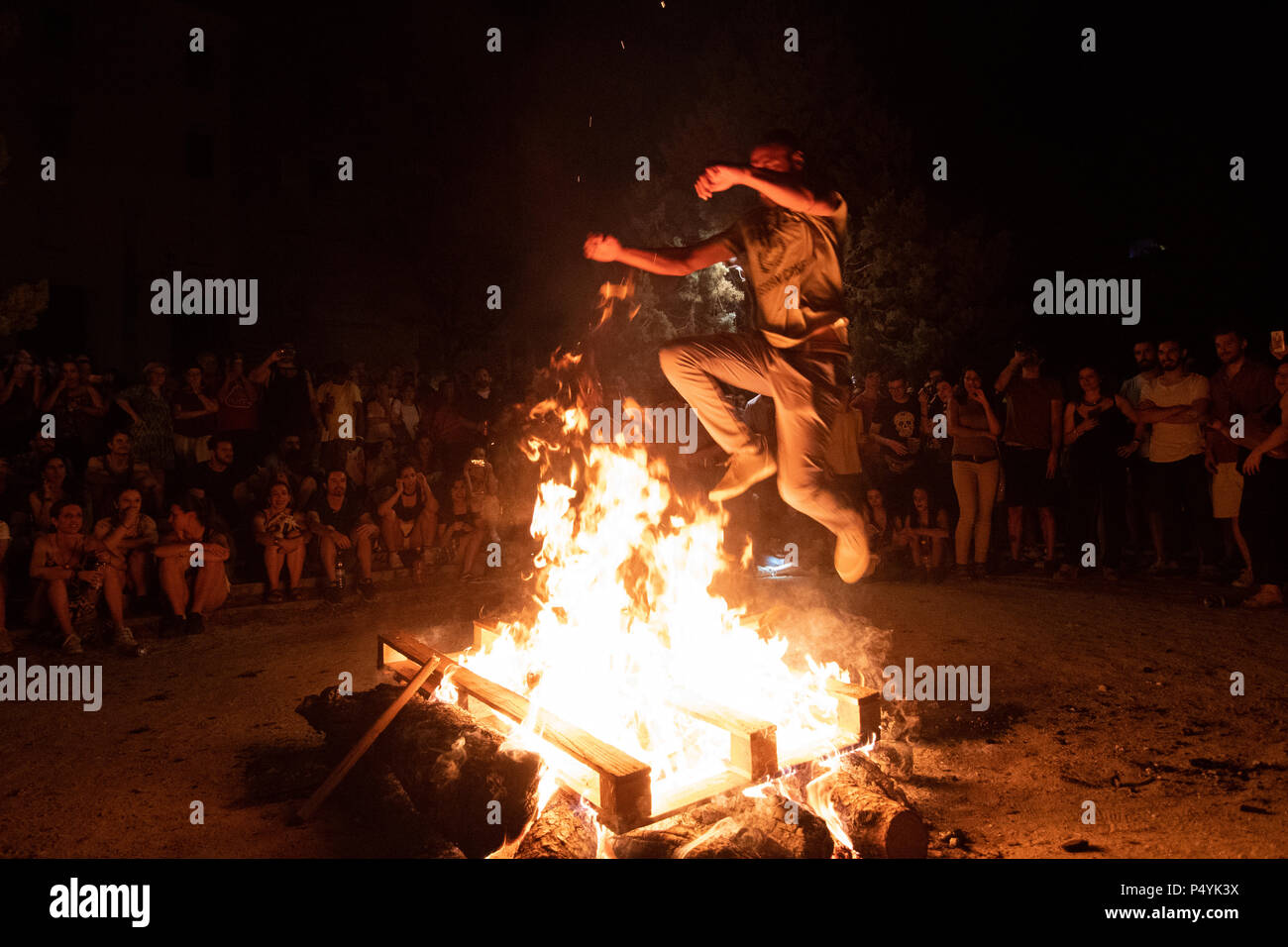 Madrid, Spain. 23rd June, 2018. A man jumping a huge bonfire during ...