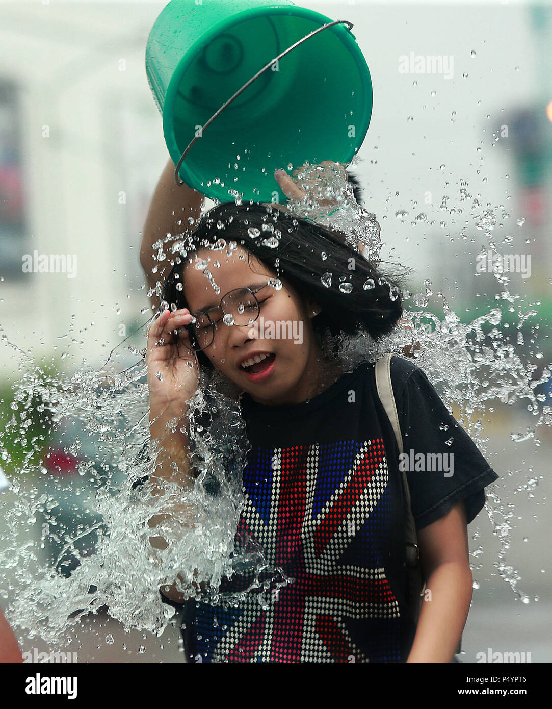 San Juan City, Philippines. 24th June, 2018. A reveller splashes water ...