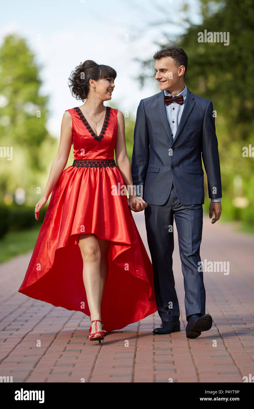 Elegant young couple having a walk in the park Stock Photo - Alamy