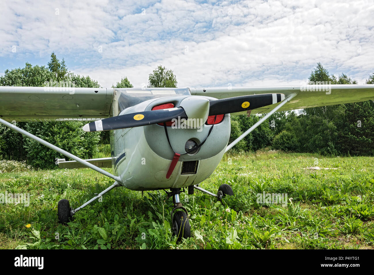 Single-engine plane close - up is on the green grass of the ground ...
