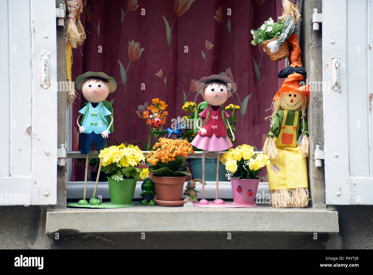 Puppets or dolls on display in home window in the old city of Le Mans ...