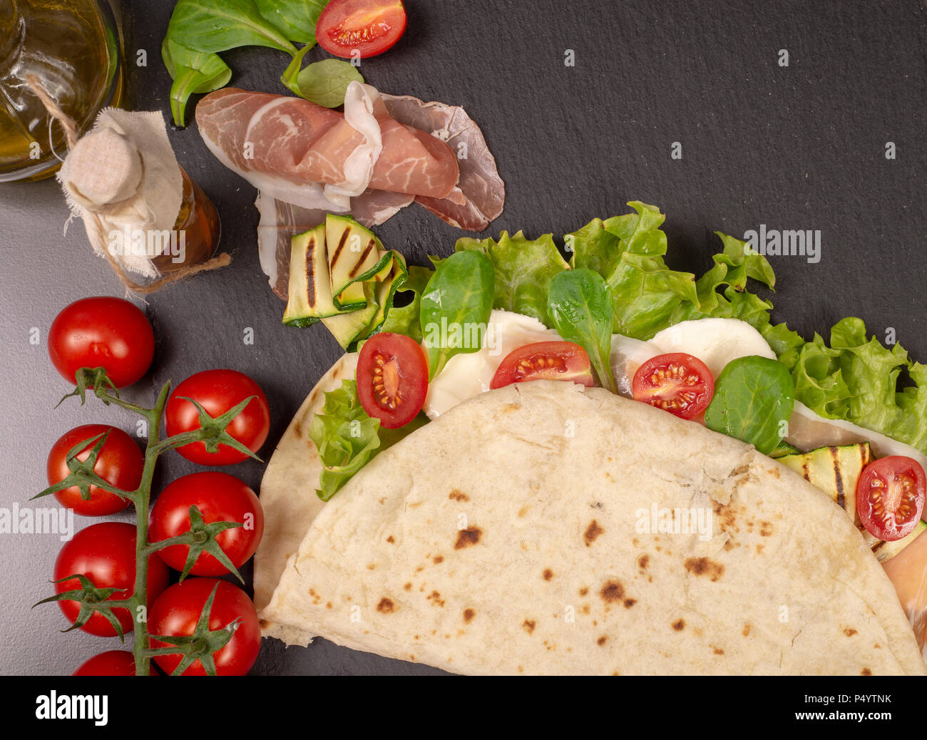 Italian piadina romagnola flatbread with lettuce, cherry tomatoes ...