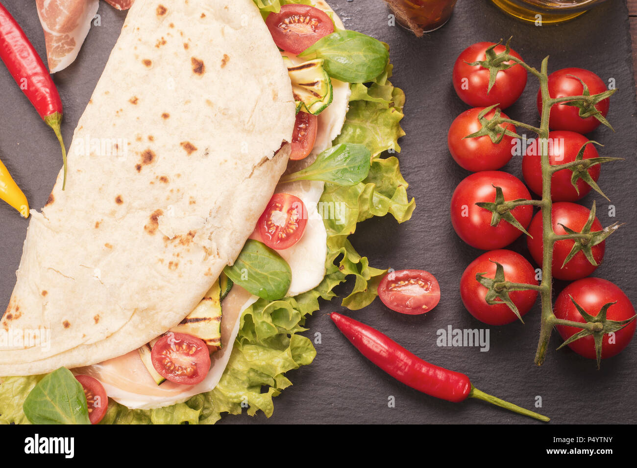Italian piadina romagnola flatbread with lettuce, cherry tomatoes ...