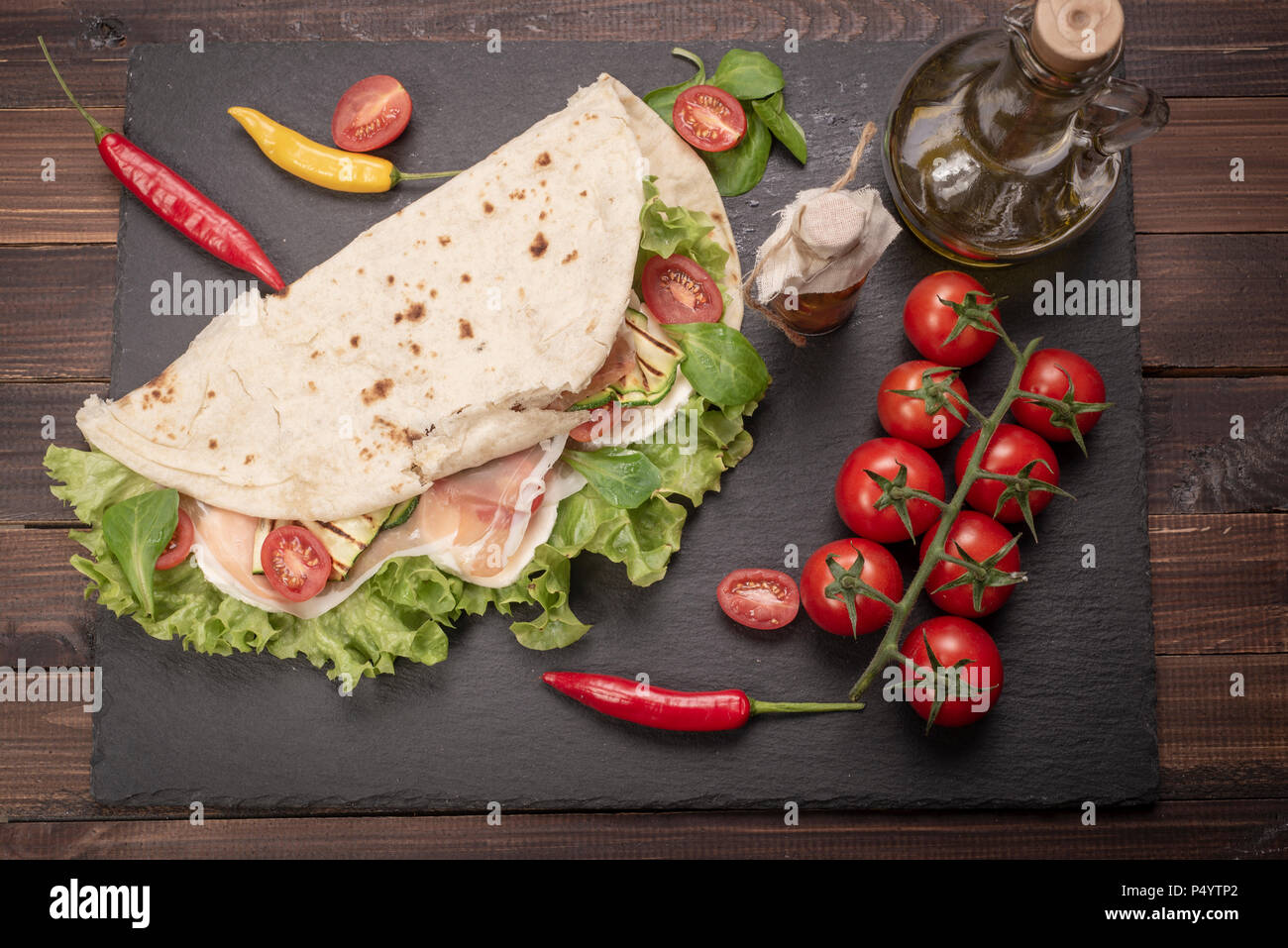 Italian piadina romagnola flatbread with lettuce, cherry tomatoes ...