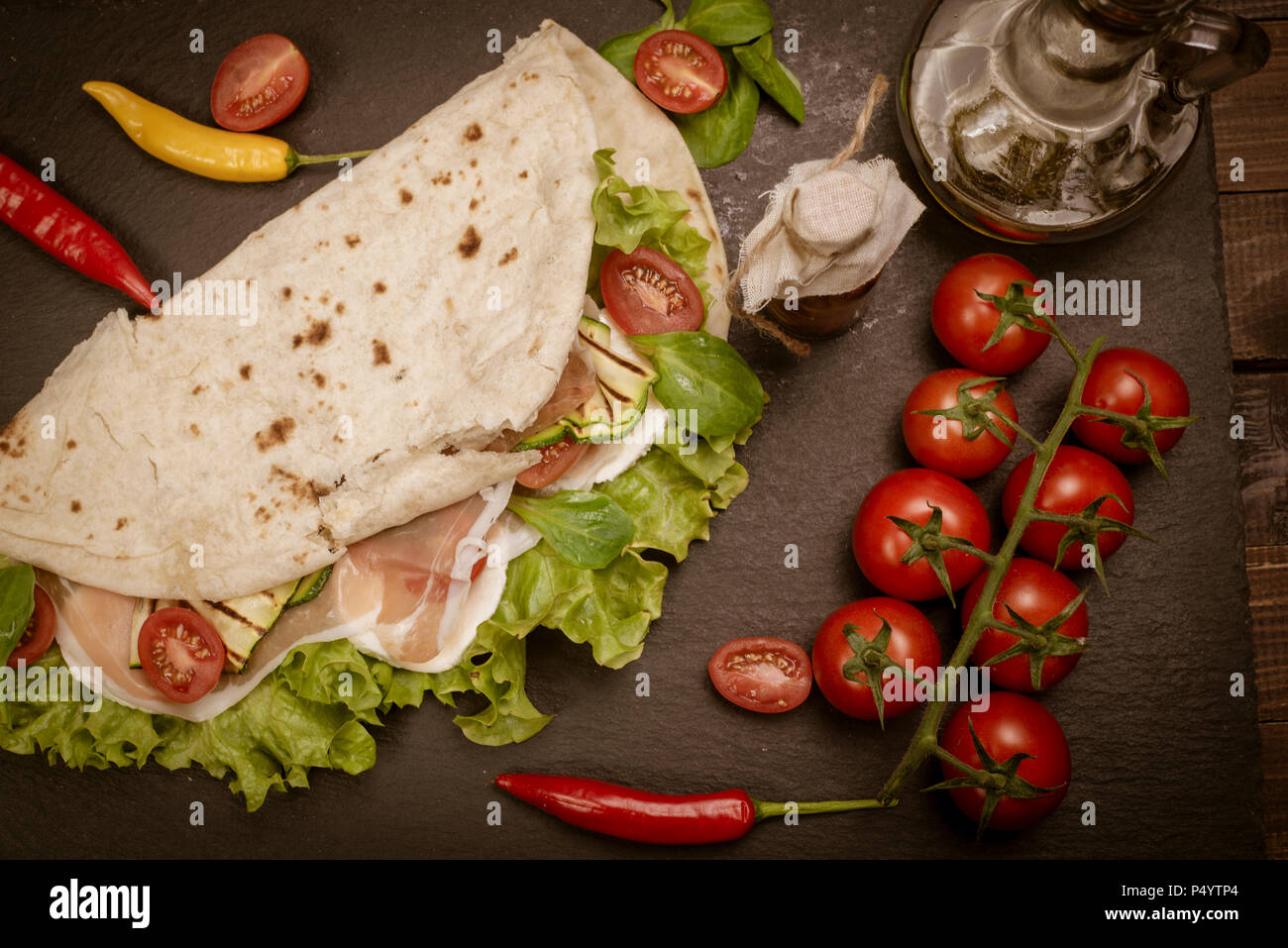 Italian piadina romagnola flatbread with lettuce, cherry tomatoes ...