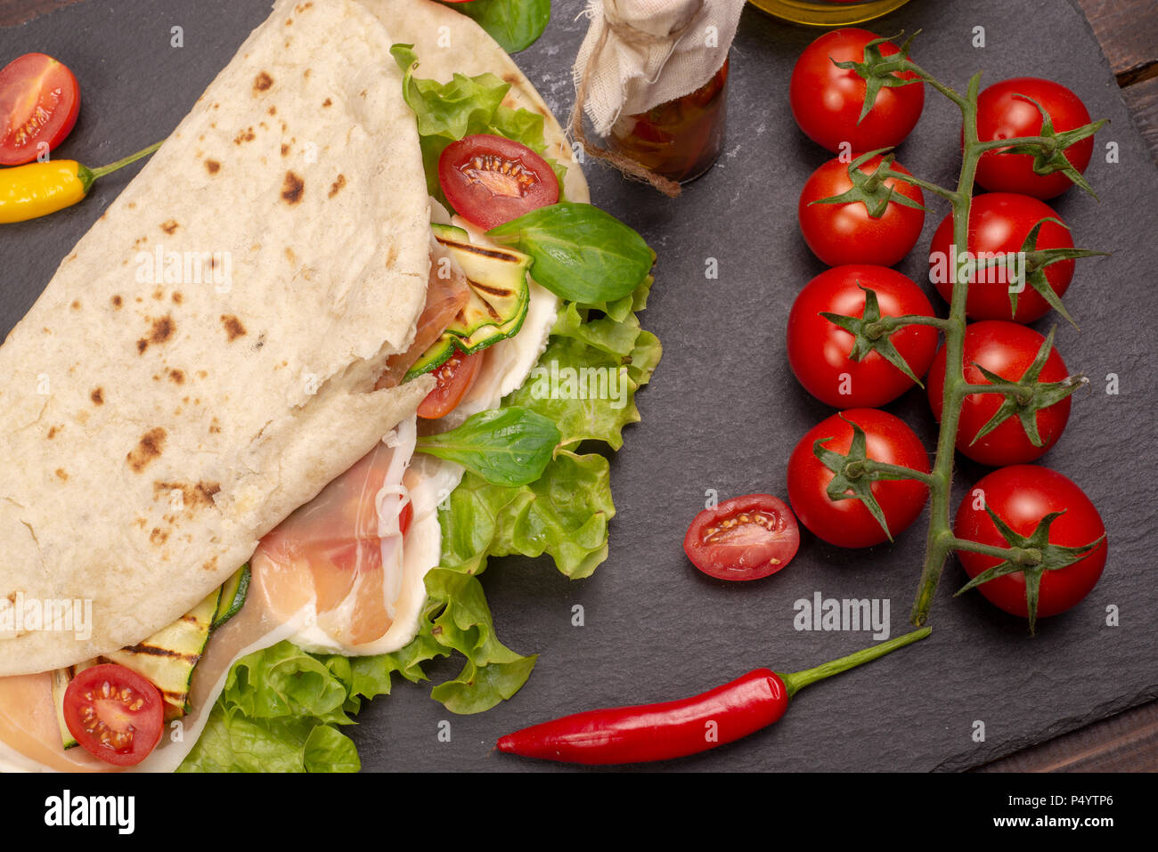 Italian piadina romagnola flatbread with lettuce, cherry tomatoes ...