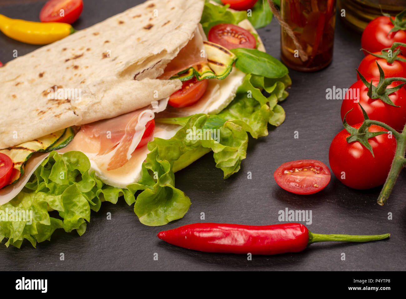 Italian piadina romagnola flatbread with lettuce, cherry tomatoes ...