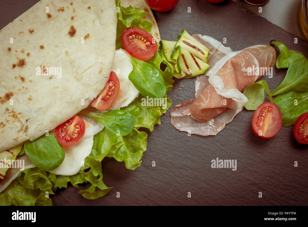 Italian piadina romagnola flatbread with lettuce, cherry tomatoes ...
