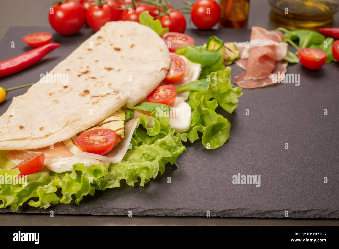 Italian piadina romagnola flatbread with lettuce, cherry tomatoes ...