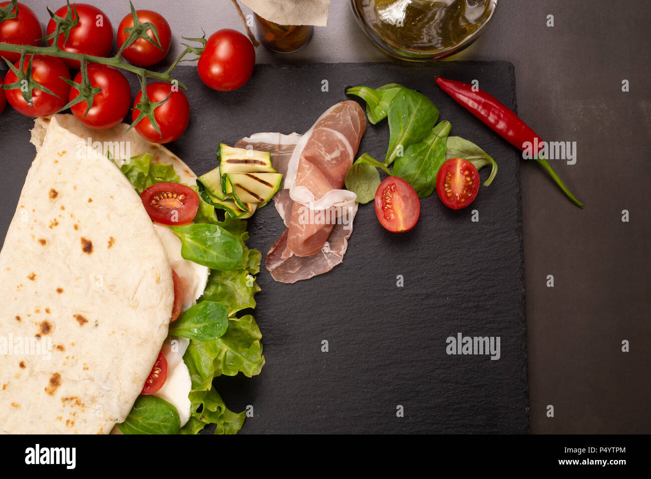 Italian piadina romagnola flatbread with lettuce, cherry tomatoes ...