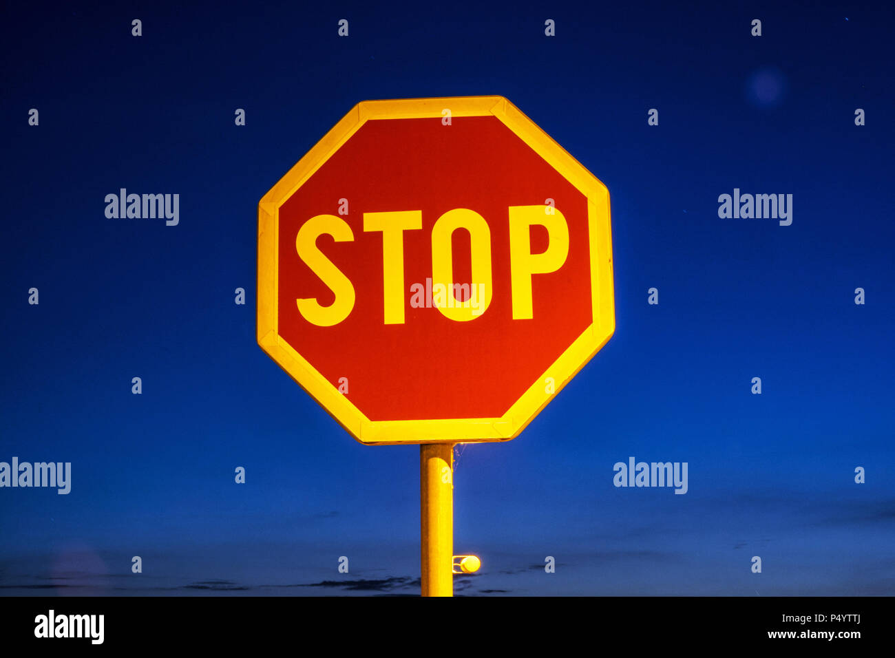Stop sign in the night city. Traffic regulation. Blue sky Stock Photo ...