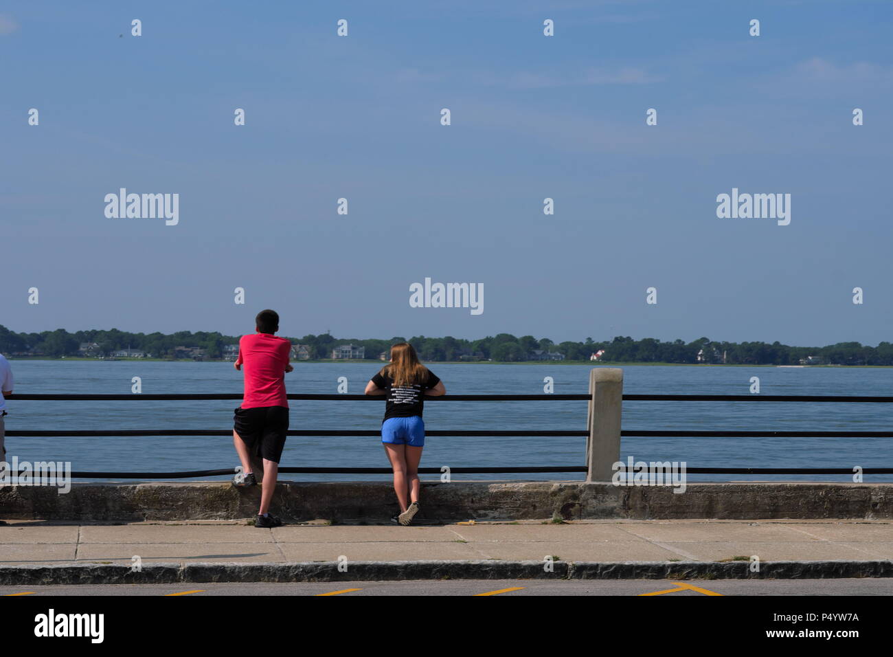 Couple Viewing Passing Boat and Ship Water Traffic Stock Photo - Alamy