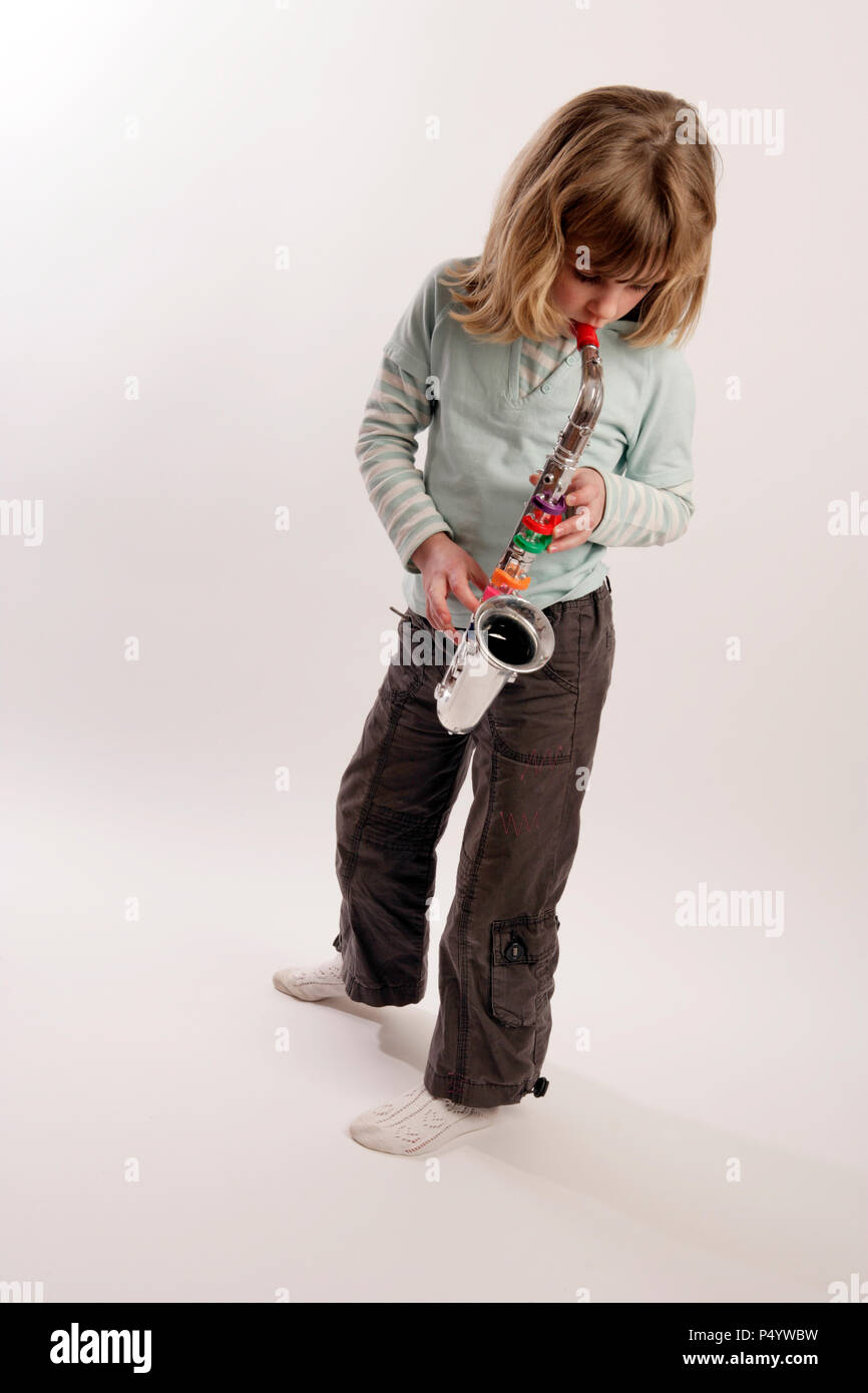 child playing a toy saxophone Stock Photo - Alamy