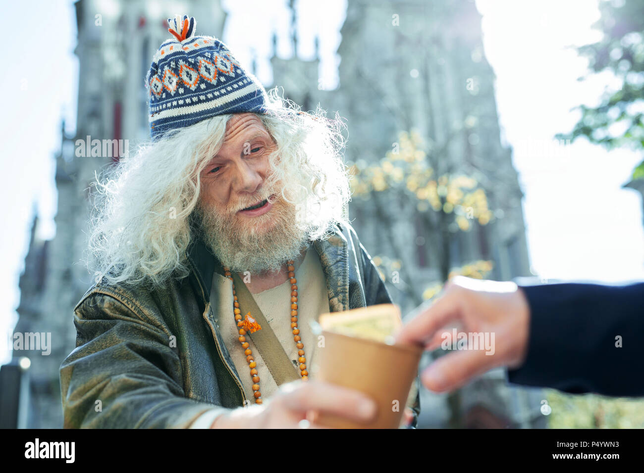 Homeless musician wearing old leather jacket Stock Photo - Alamy