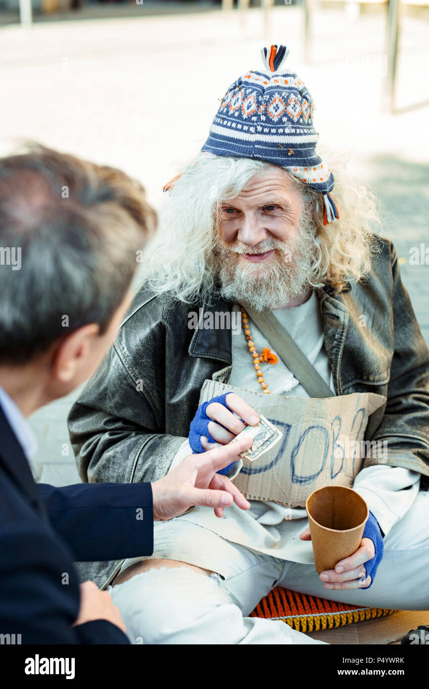 Unemployed elderly hippy man begging for help Stock Photo - Alamy