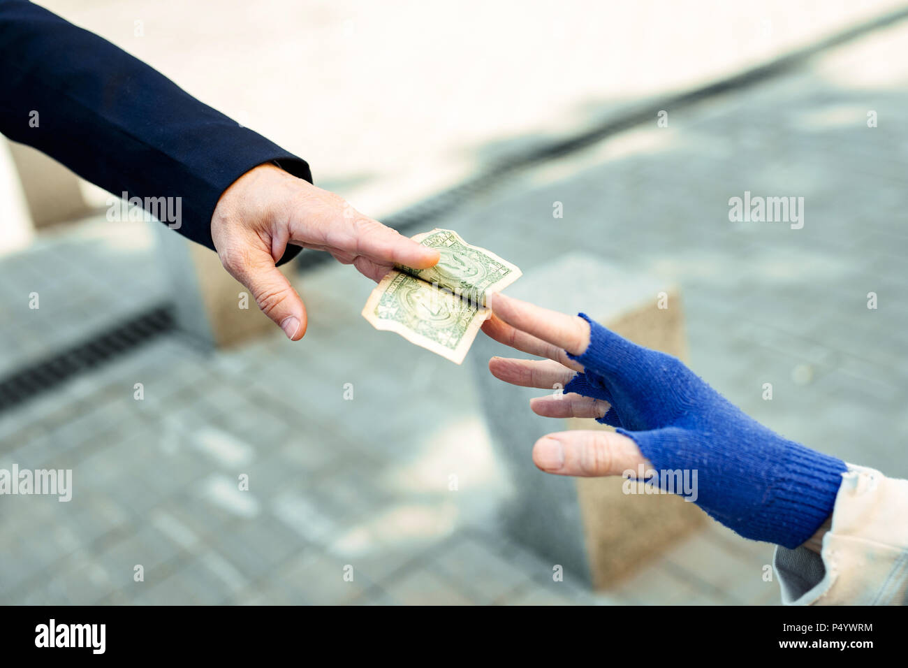 Street man wearing tattered blue gloves taking money Stock Photo - Alamy