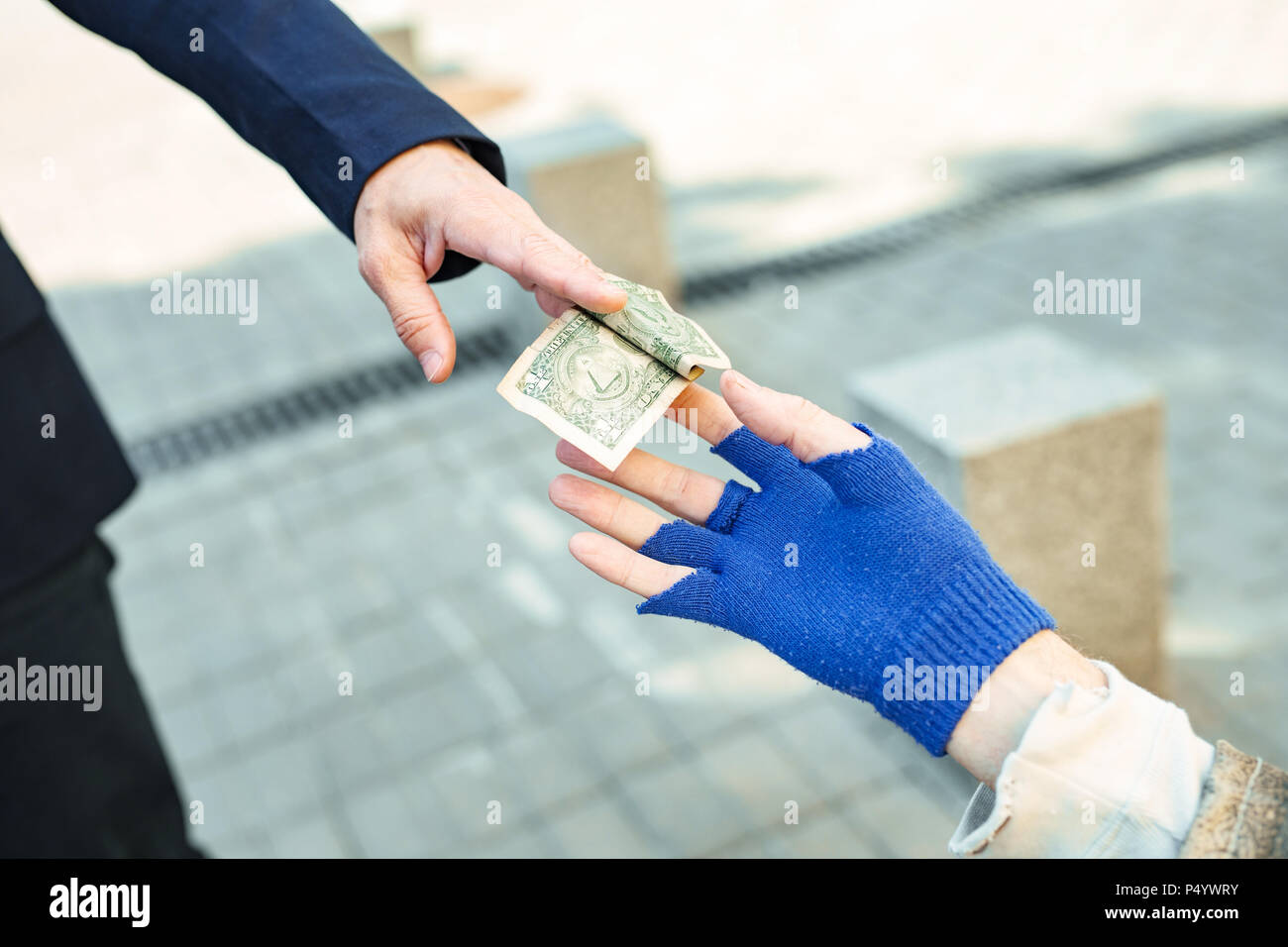 Helpful stranger in black suit giving money to homeless Stock Photo - Alamy