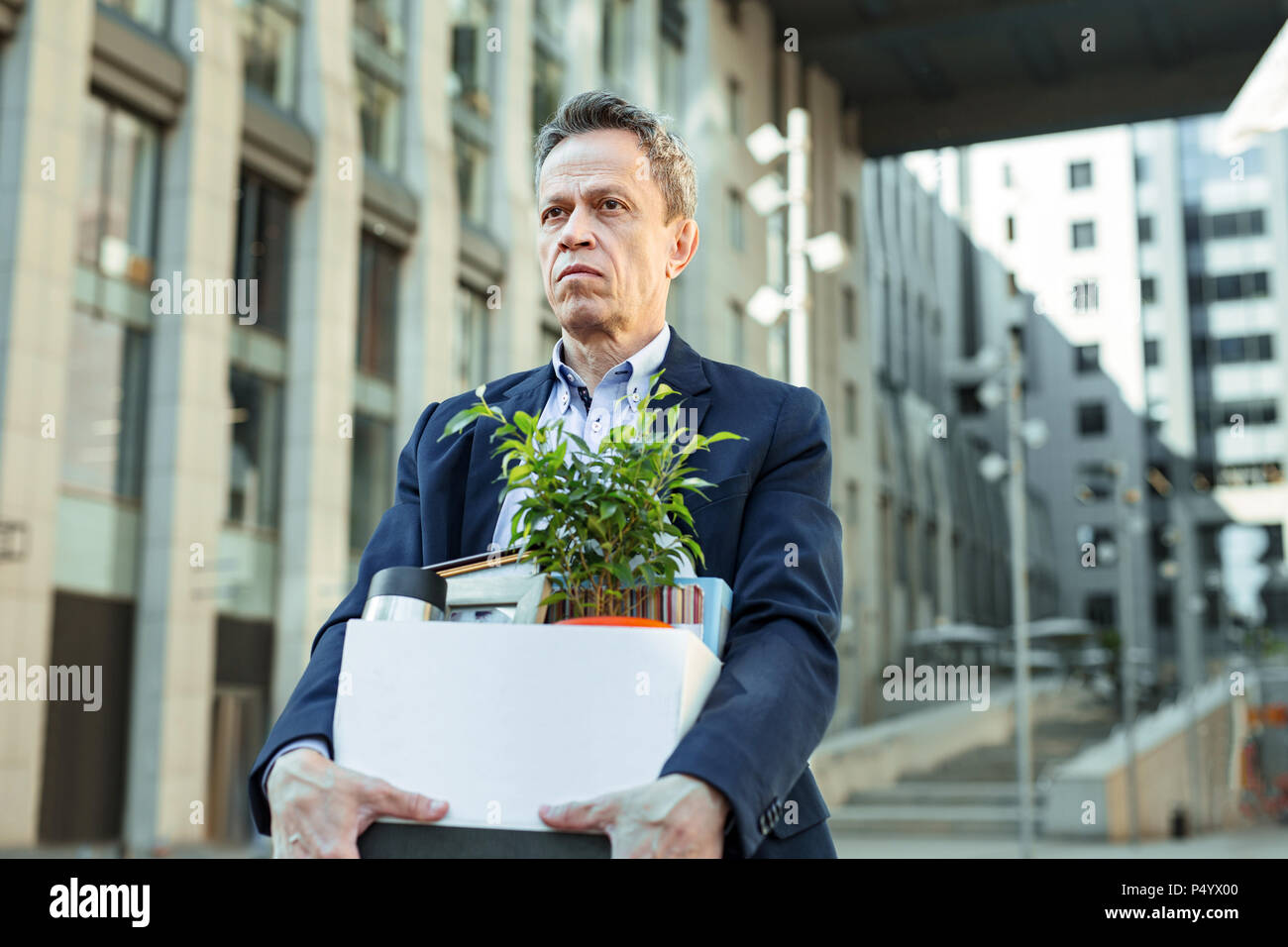 Grey-haired man feeling perplexed after taking a drop in salary Stock ...