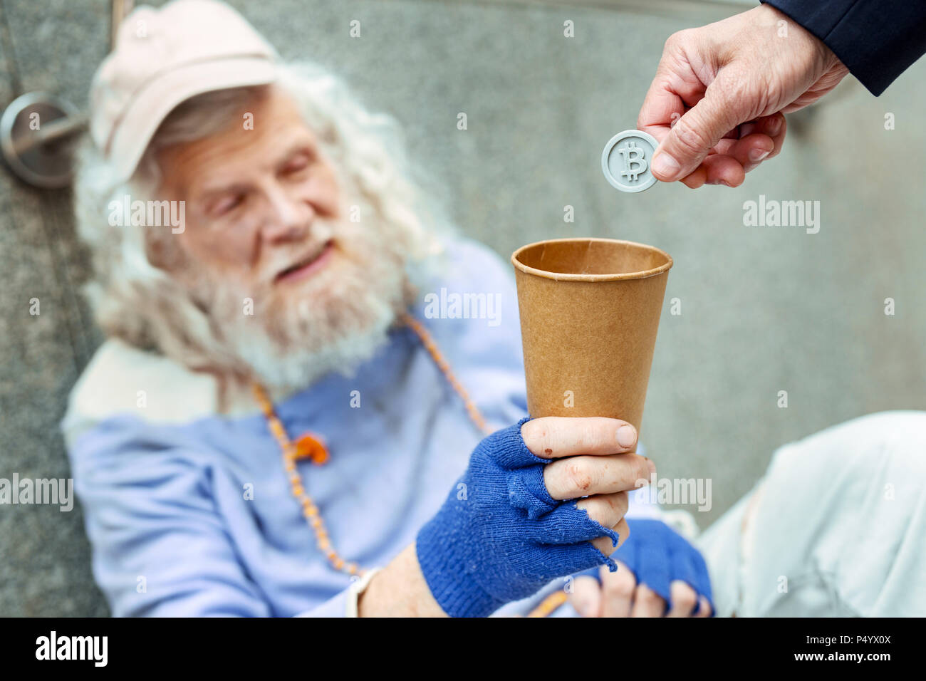 Sympathetic friendly stranger giving token for street man Stock Photo ...