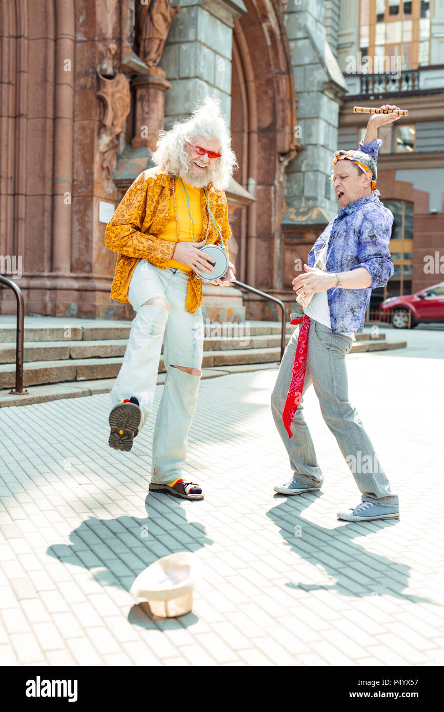 Two flower-children feeling delighted while dancing together Stock ...