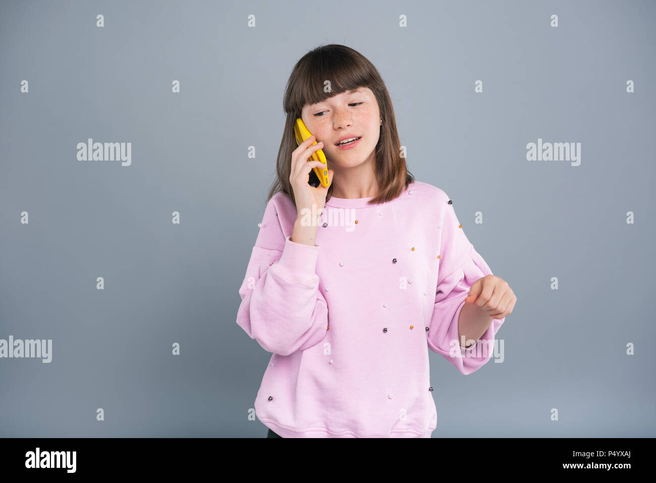 Pleasant teenage girl making a phone call Stock Photo - Alamy
