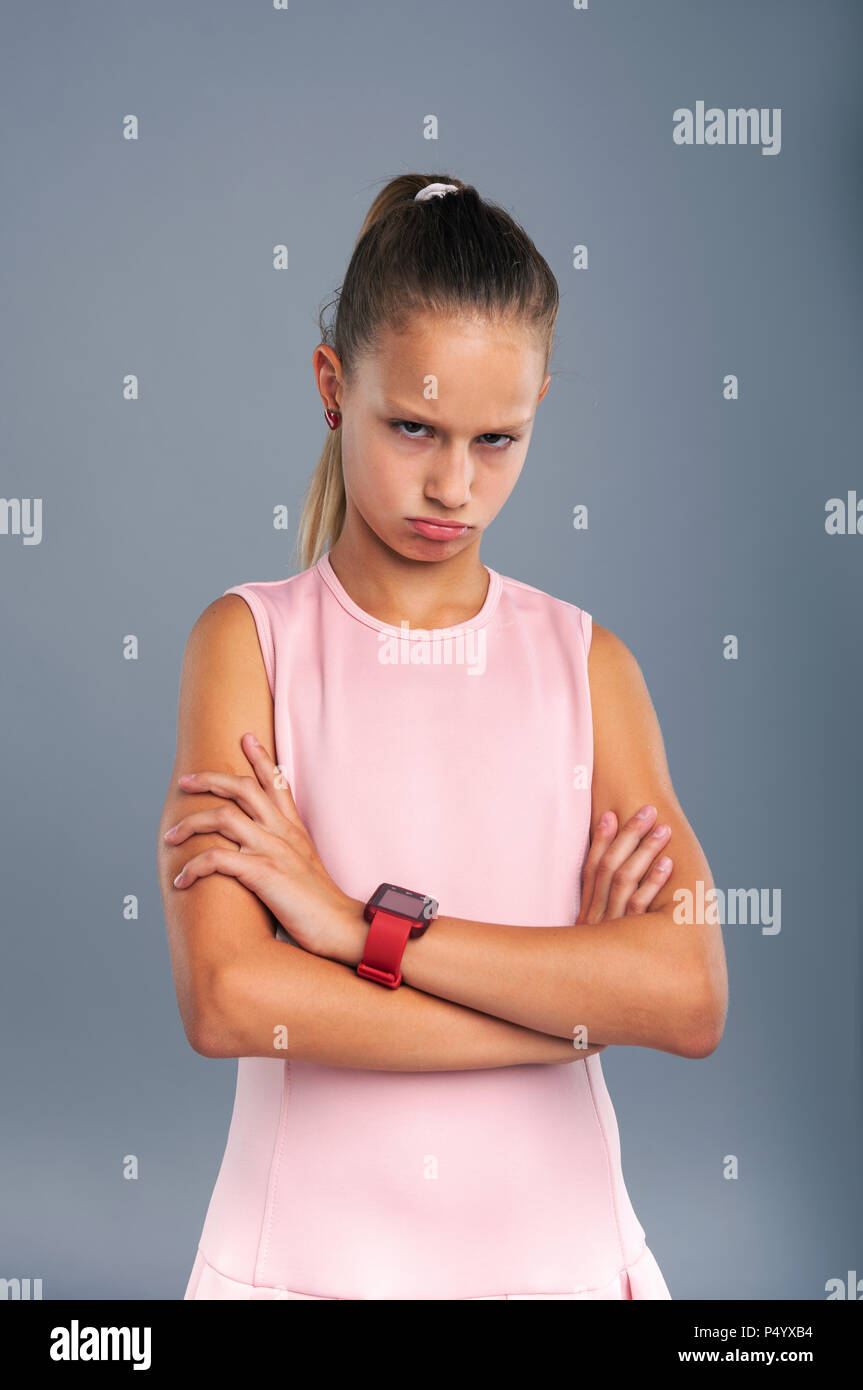 Adorable teenage girl glaring and crossing her arms Stock Photo - Alamy