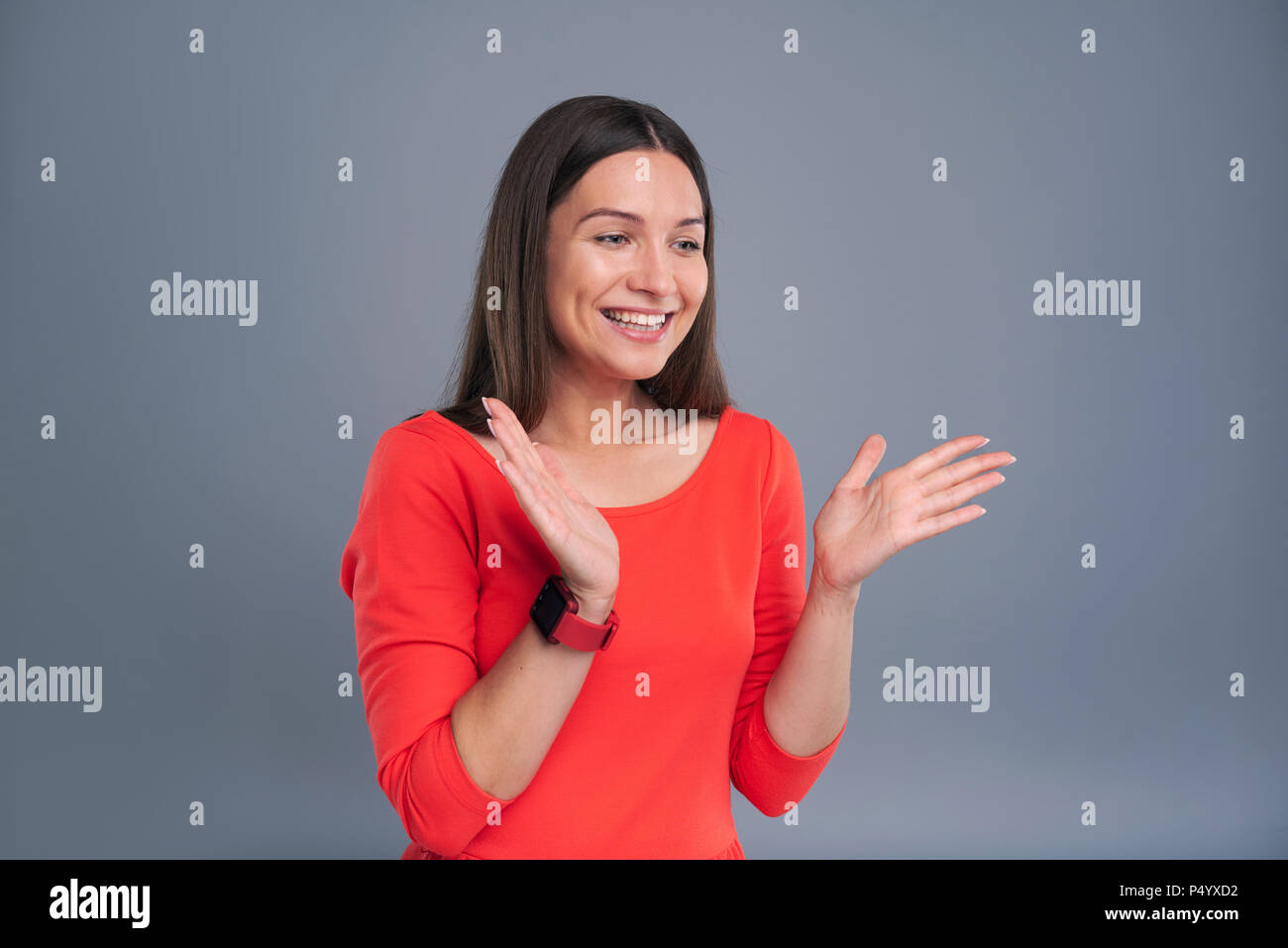 Pleasant young woman clapping hands happily Stock Photo - Alamy