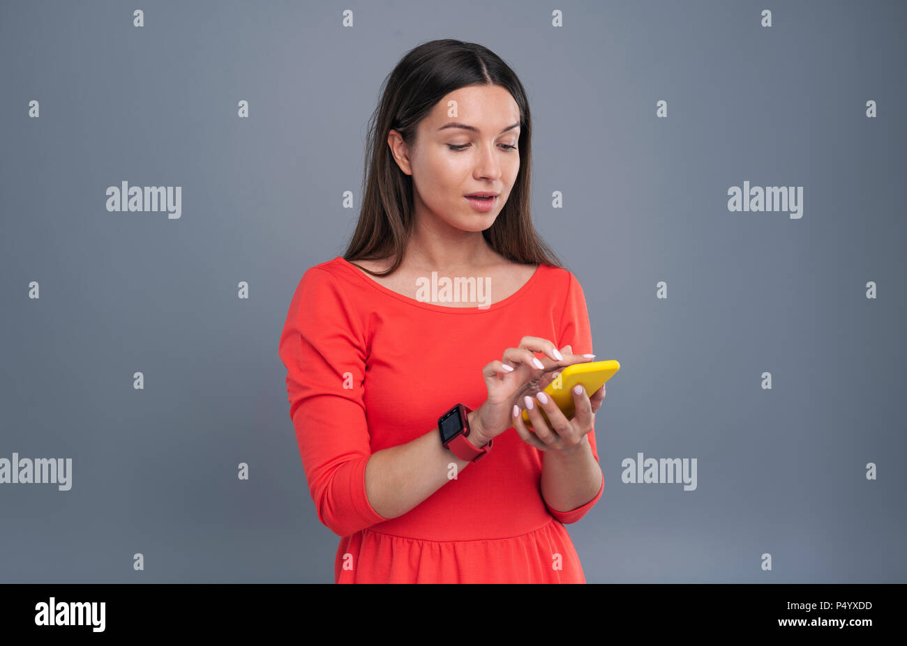 Pleasant young woman typing a text message Stock Photo - Alamy