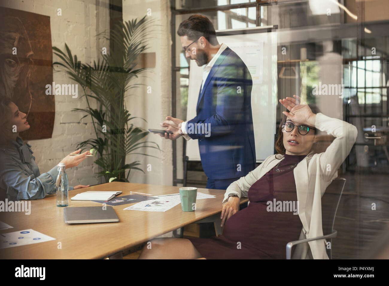 Tired three colleagues debating over problem Stock Photo - Alamy