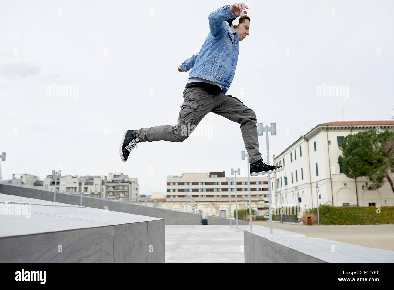 Young man jumping over gap between walls hi-res stock photography and ...