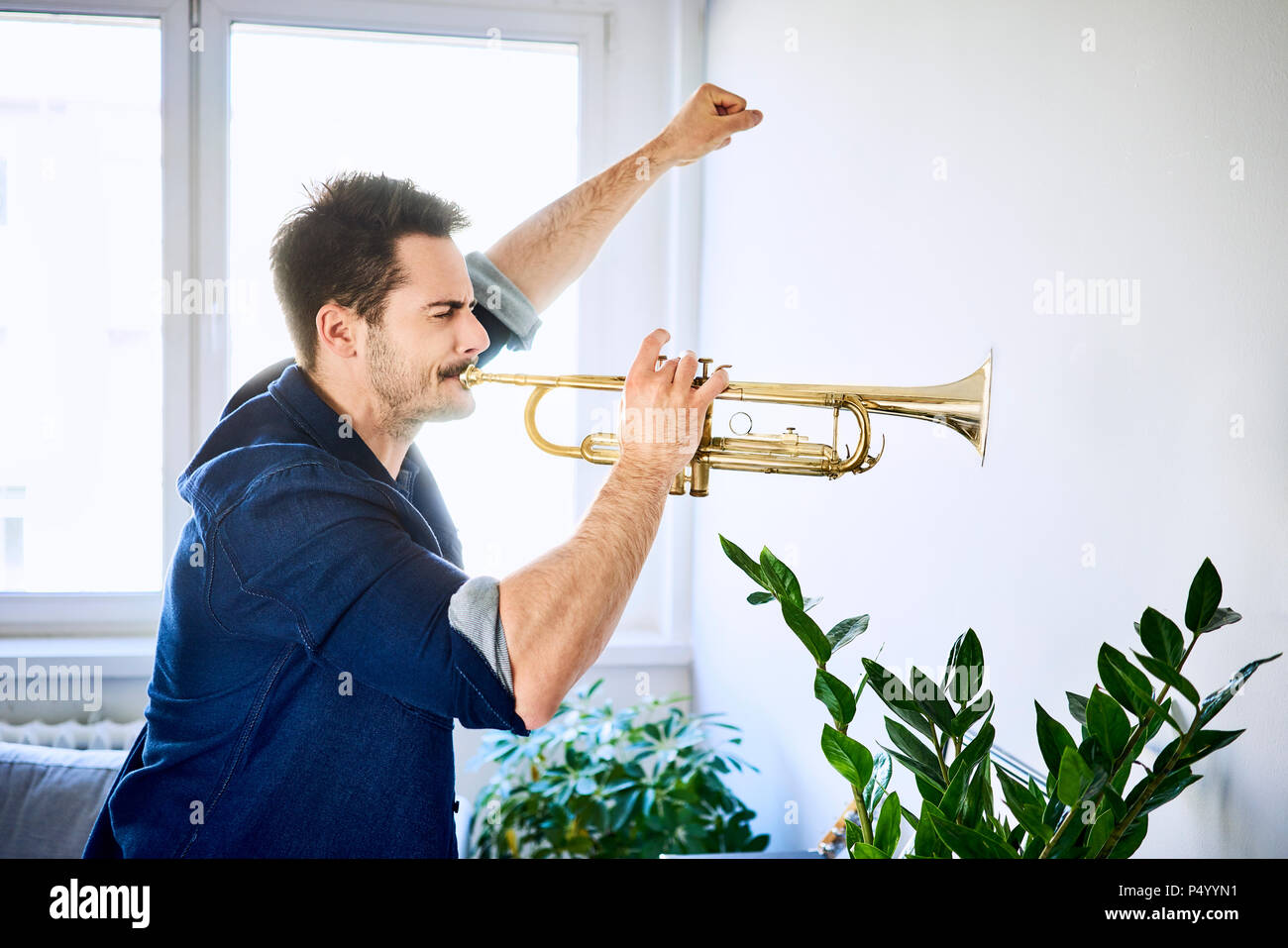 Man at home playing trumpet Stock Photo - Alamy
