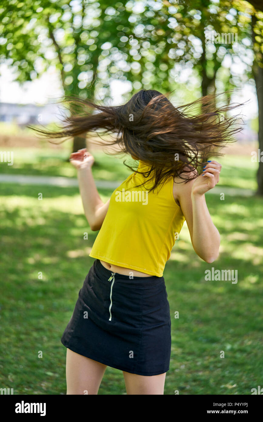 Woman tossing hair in park hi-res stock photography and images - Alamy