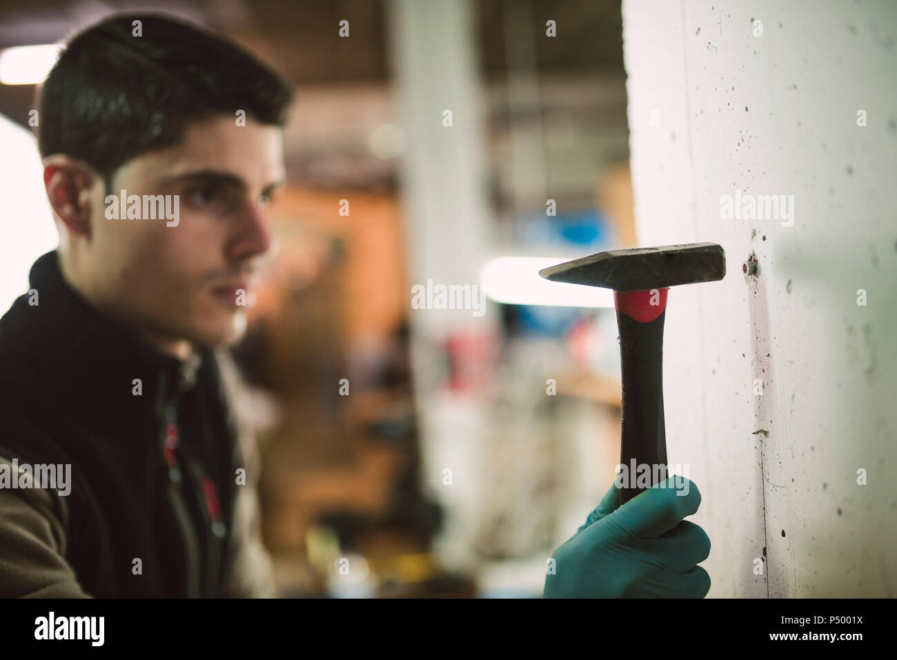 Male hand hammers dowel wall hi-res stock photography and images - Alamy