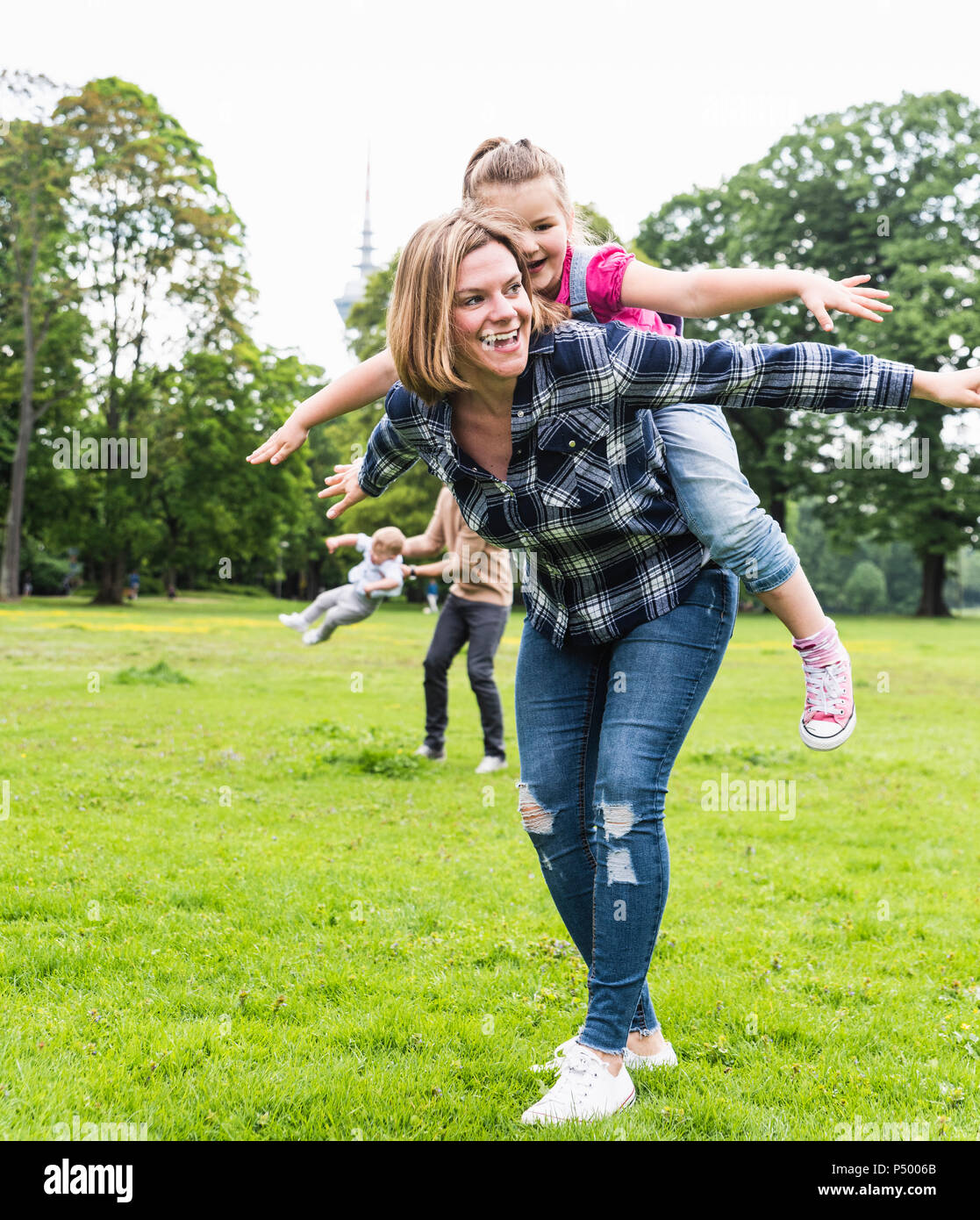 Active happy family in a park Stock Photo - Alamy