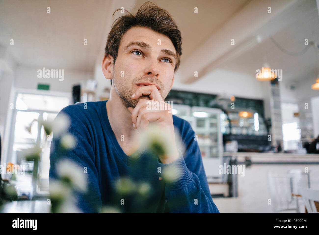 Man in a cafe thinking Stock Photo - Alamy