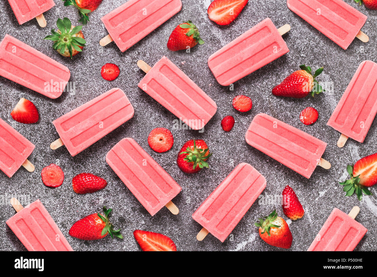 Homemade strawberry ice lollies and strawberries on marble Stock Photo ...