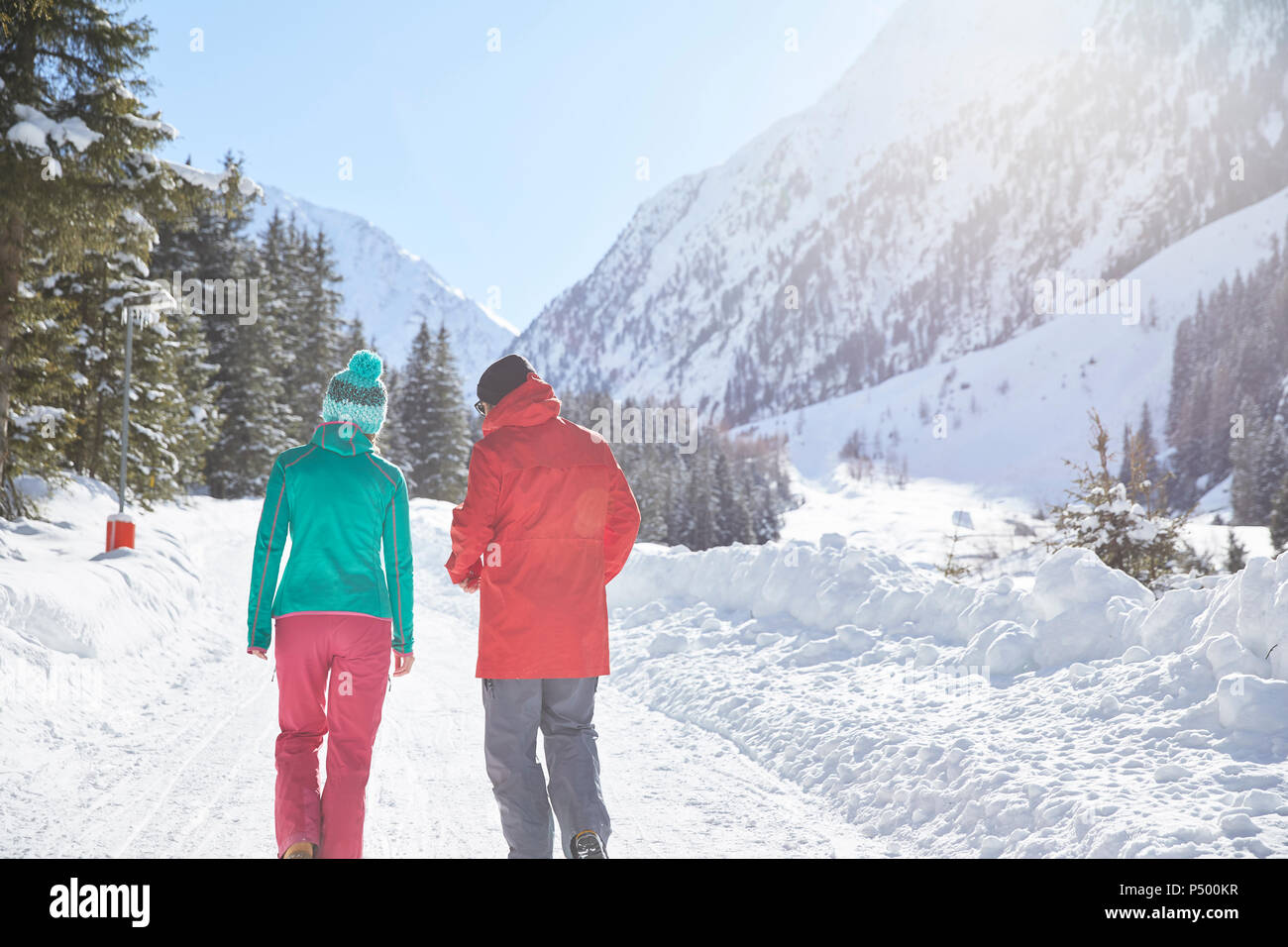 Woman walking on snow trail hi-res stock photography and images - Alamy