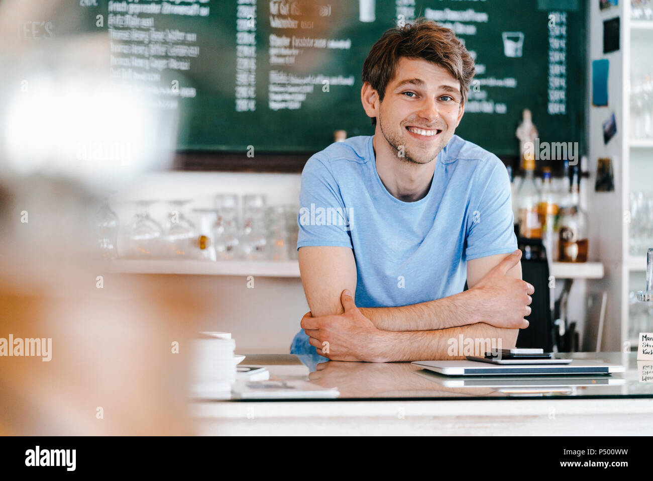 Portrait of smiling man in a cafe Stock Photo - Alamy