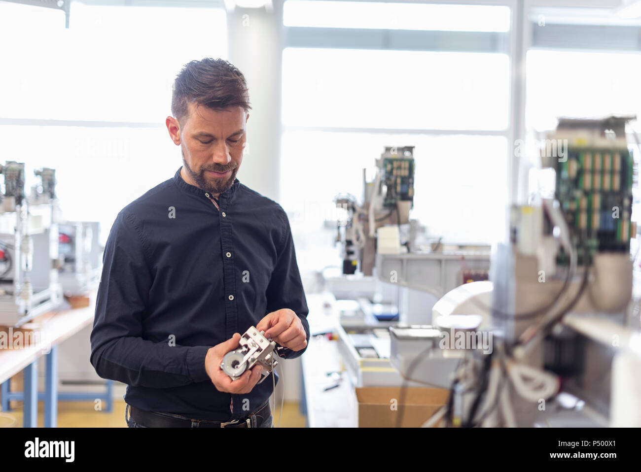 Man in factory examining product Stock Photo - Alamy