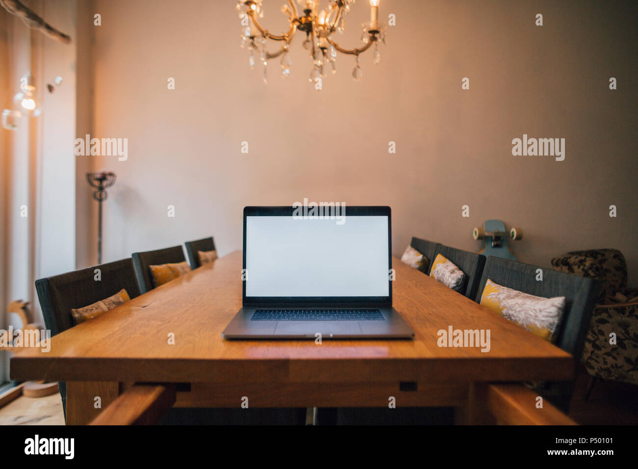 Laptop on dining table Stock Photo - Alamy