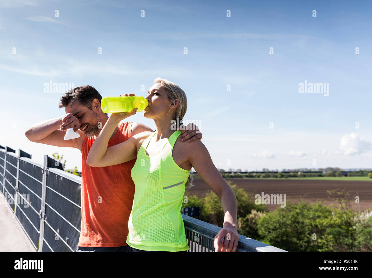 Fit couple jogging in the city, having fun, taking a break Stock Photo ...