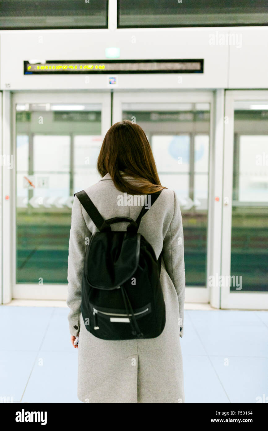 Back view of woman with black backpack Stock Photo - Alamy